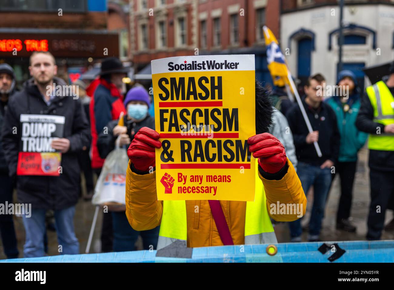 Leeds, UK. 23 NOV, 2024. Demonstrator holds "Smash Fascism and Racism ...