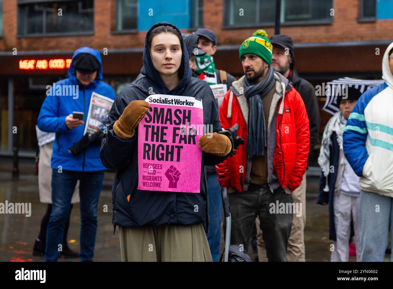 Leeds, UK. 23 NOV, 2024. Demonstrator holds "Smash the Far right" sign ...