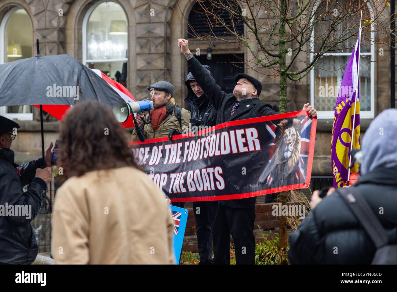 Leeds, UK. 23 NOV, 2024. Protestor on the right leaning side raises ...