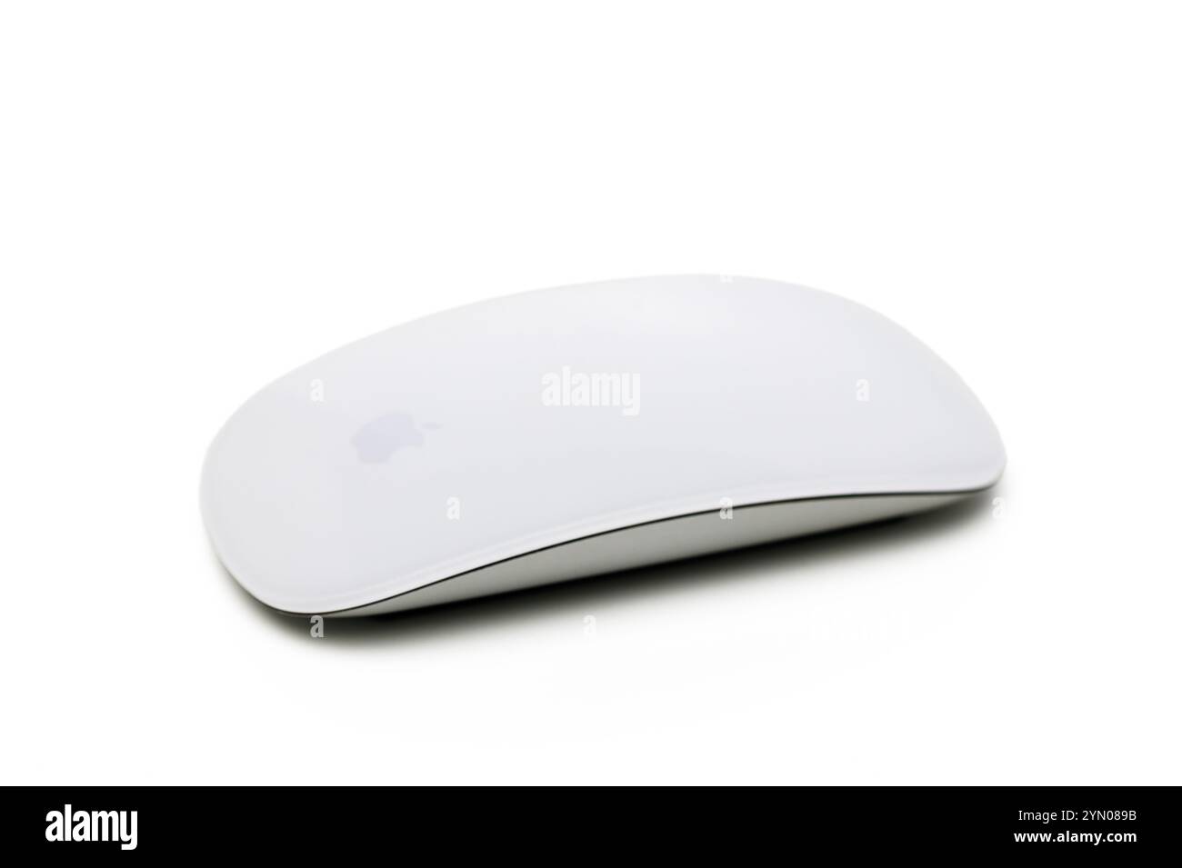 A modern wireless mouse with a smooth design sitting on a clean ...