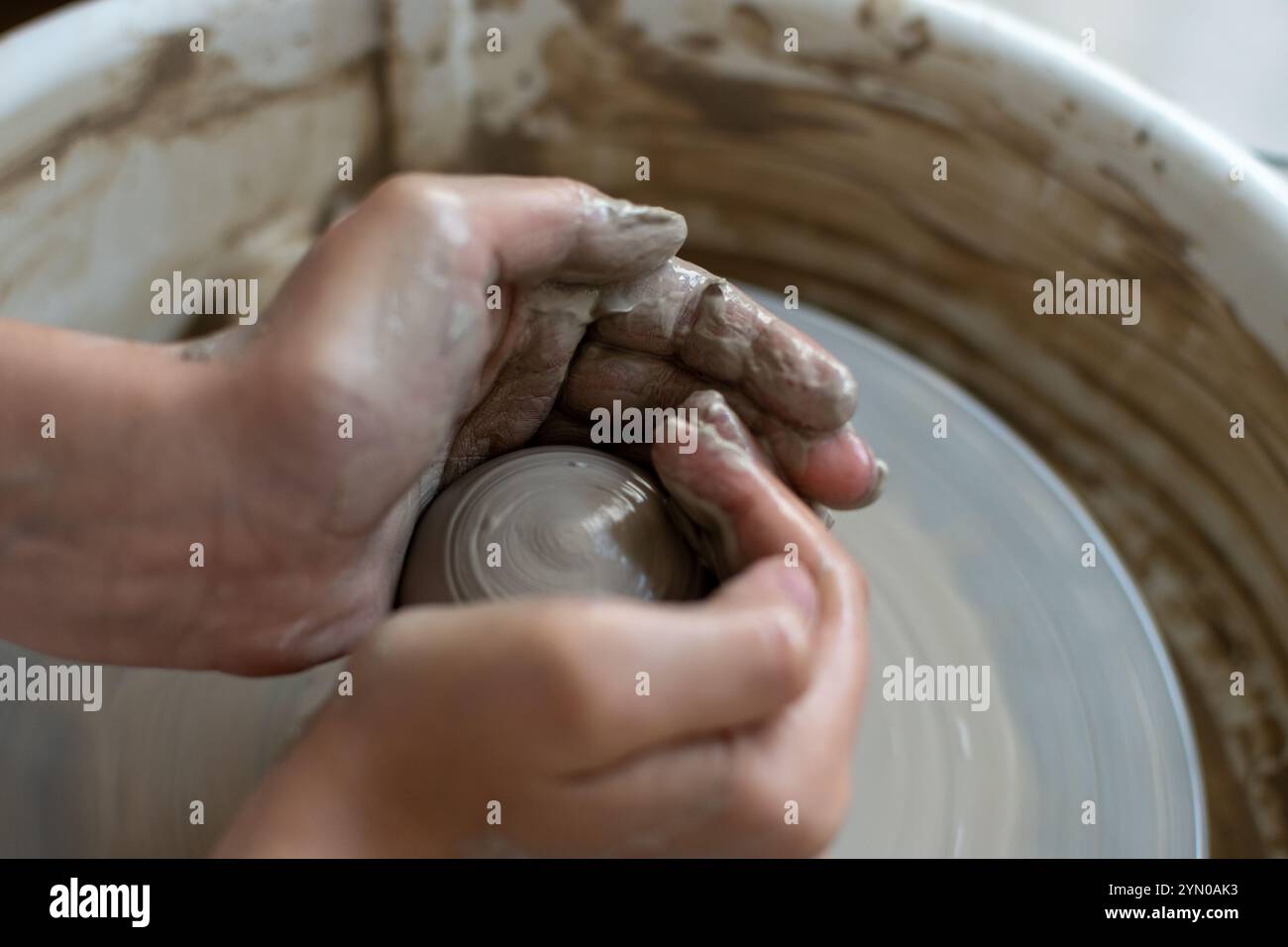 Making of mud pot on potters wheel during workshop in design modern art ...