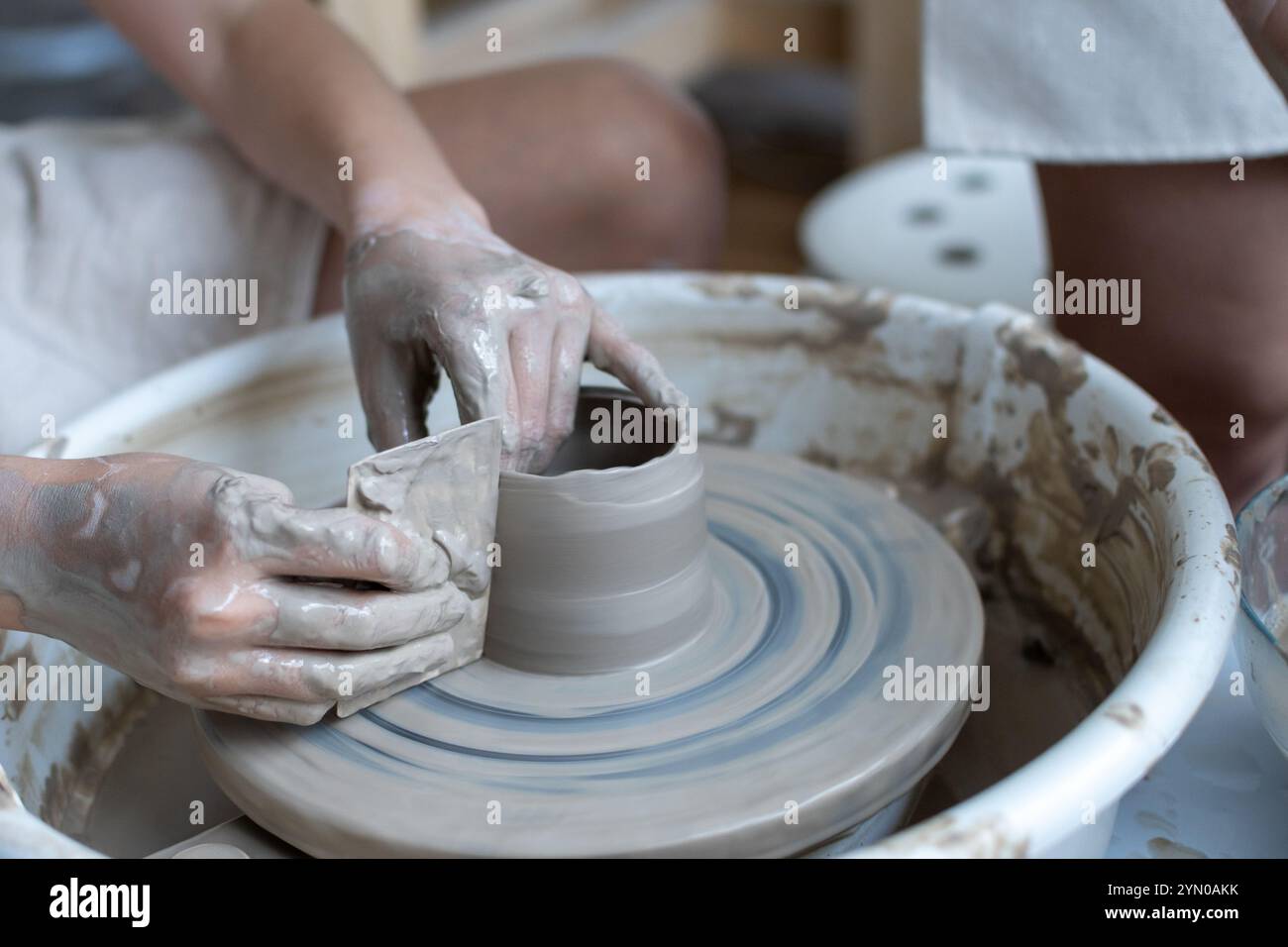 Making of mud pot on potters wheel during workshop in design modern art ...