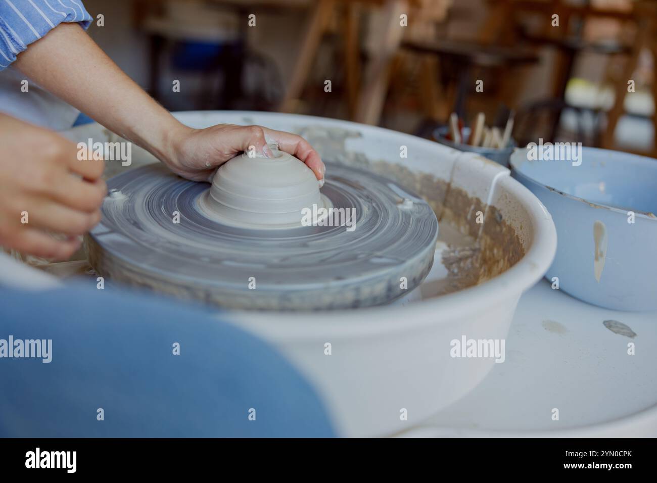 Creating artisan pottery on a wheel involves a meticulous process that ...