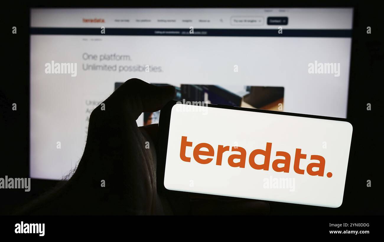 Stuttgart, Germany, 07-05-2024: Person holding mobile phone with logo of American database ...