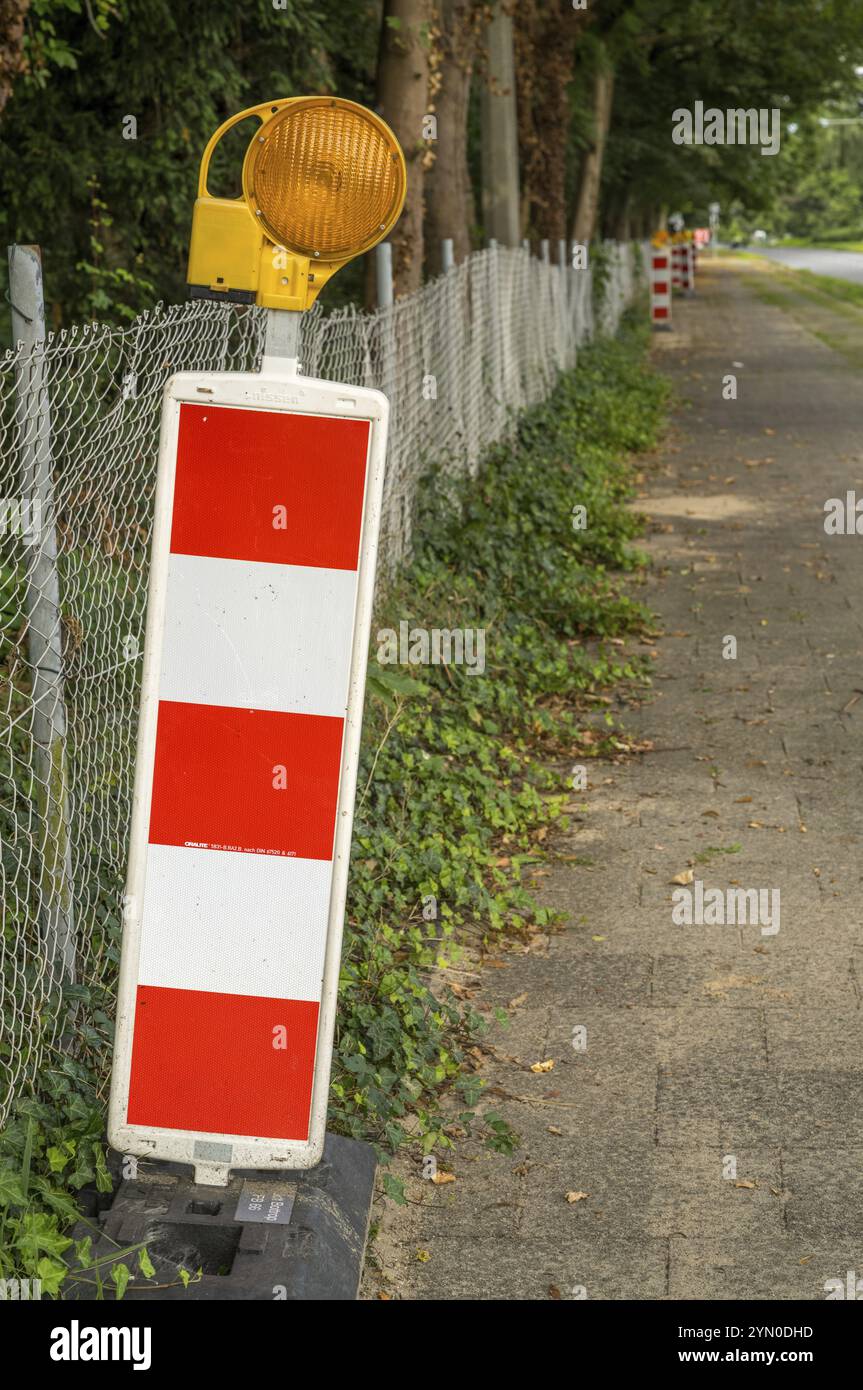Walkway with wire fence and warning beacons Stock Photo - Alamy