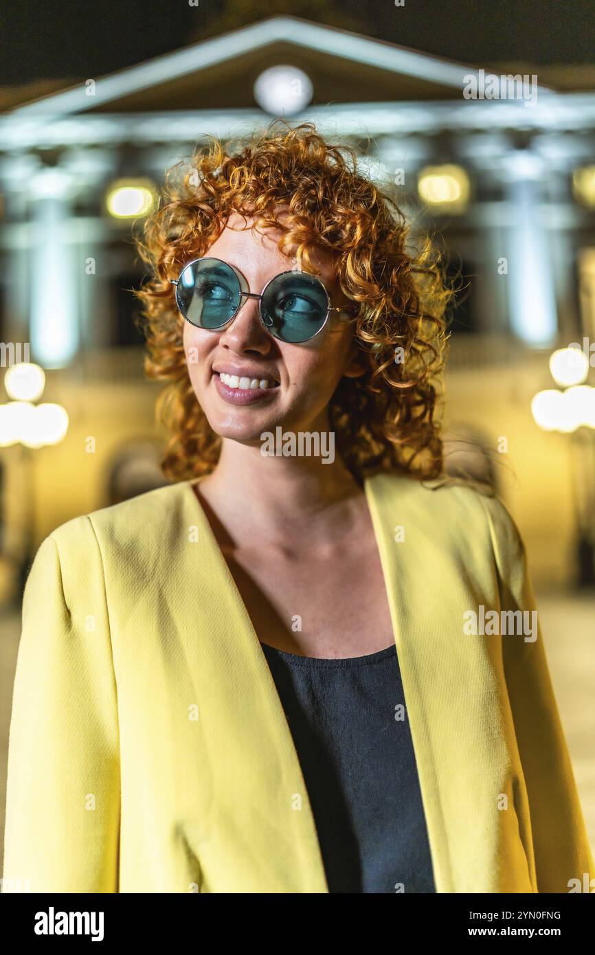 Vertical portrait of a modern millennial woman enjoying the night in ...
