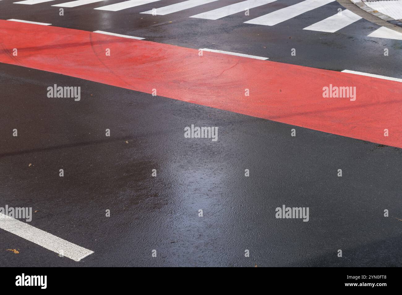 Wet street, sidewalk, bike path with traffic signs Stock Photo - Alamy