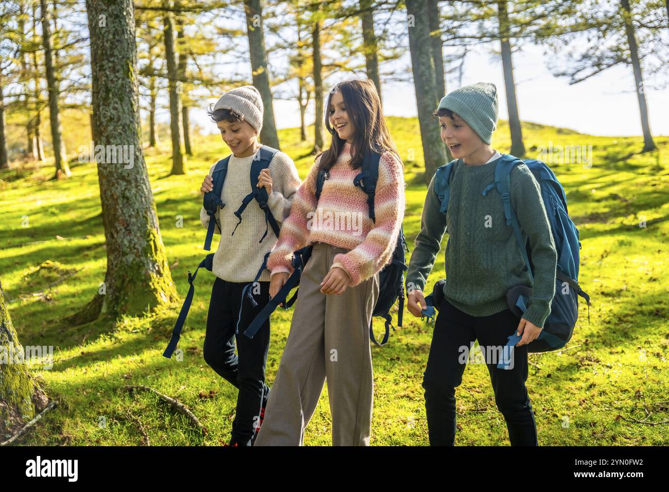 Caucasian family of two teenager brothers and one sister enjoying nature during trekking in the ...