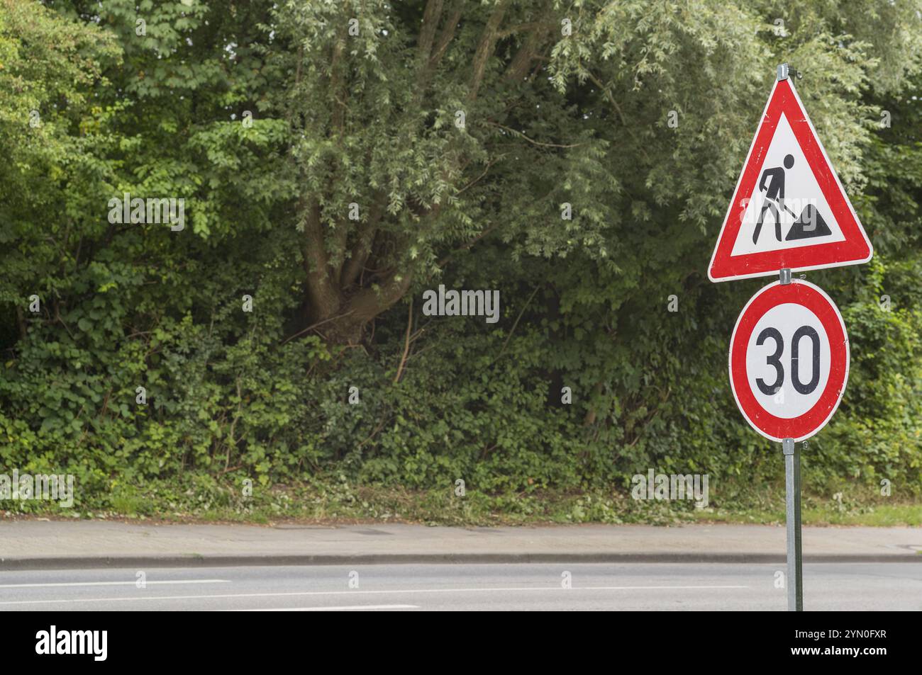 Traffic sign construction site and speed limit Stock Photo - Alamy