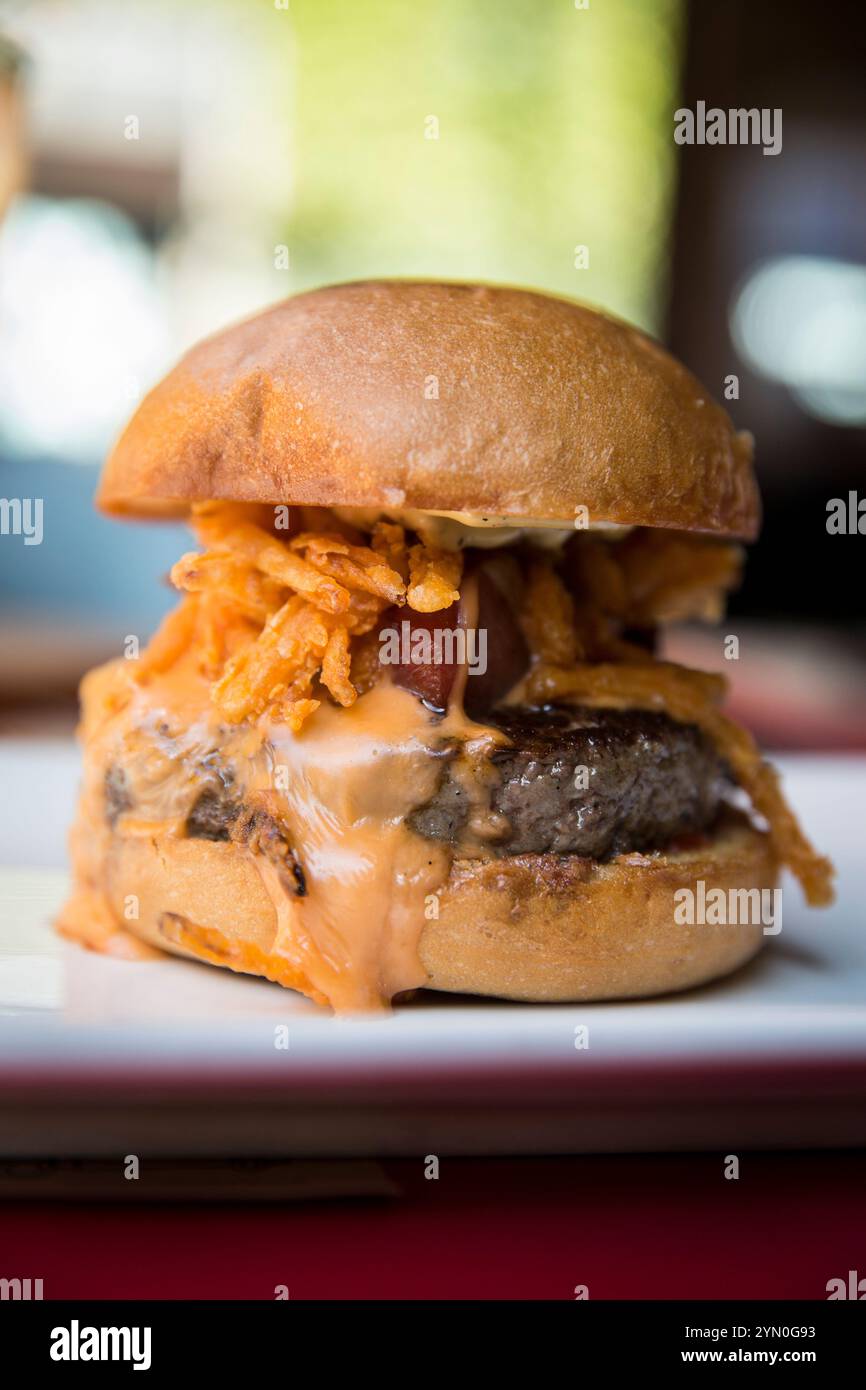 The "Manly Burger" comprised of beer-cheddar cheese, bacon lardons ...