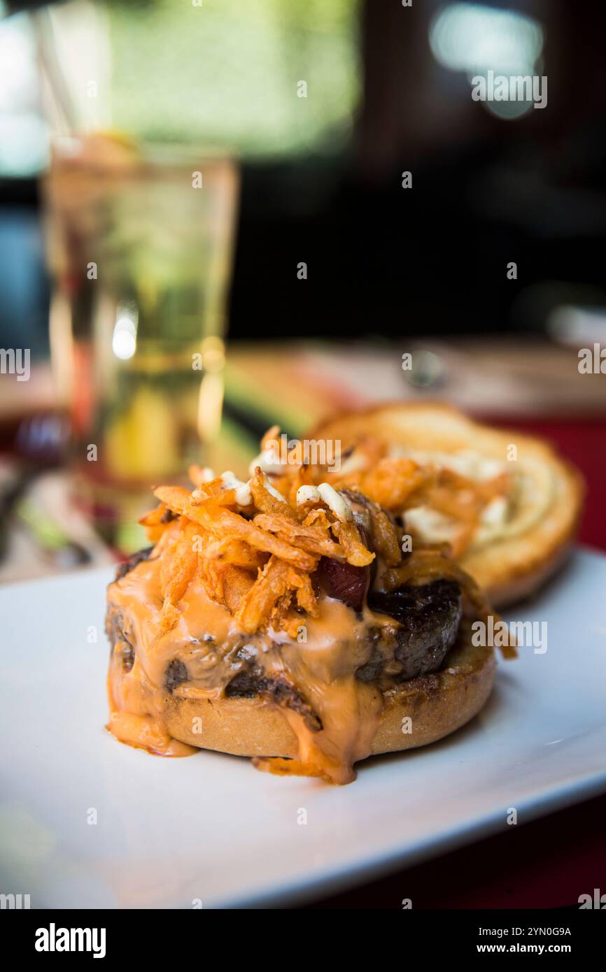 The "Manly Burger" comprised of beer-cheddar cheese, bacon lardons ...