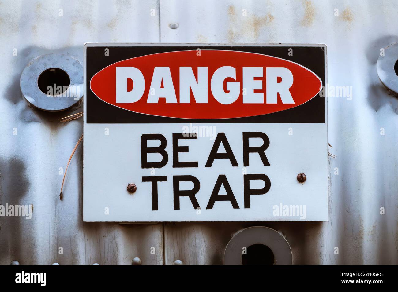 Bear Trap danger sign on metal trap and cage trailer in Yosemite ...