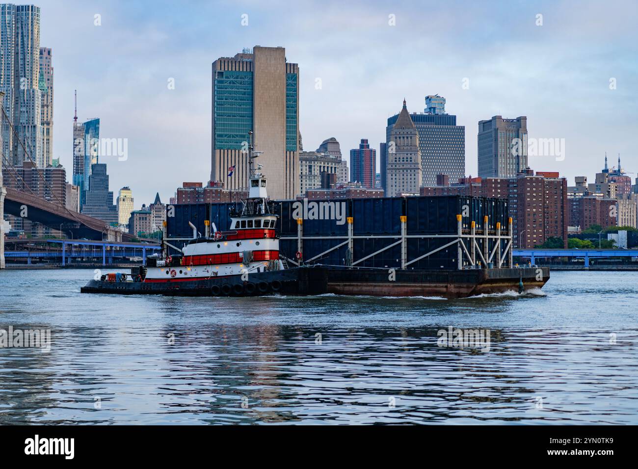 Tugboat pushing barge at Brooklyn bridge. Barge and tugboat in Hudson ...