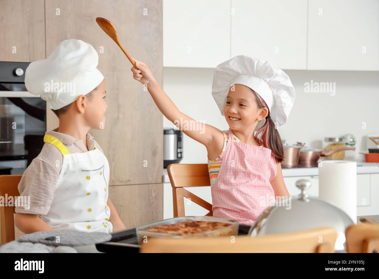 Little Asian children cooking in kitchen Stock Photo - Alamy