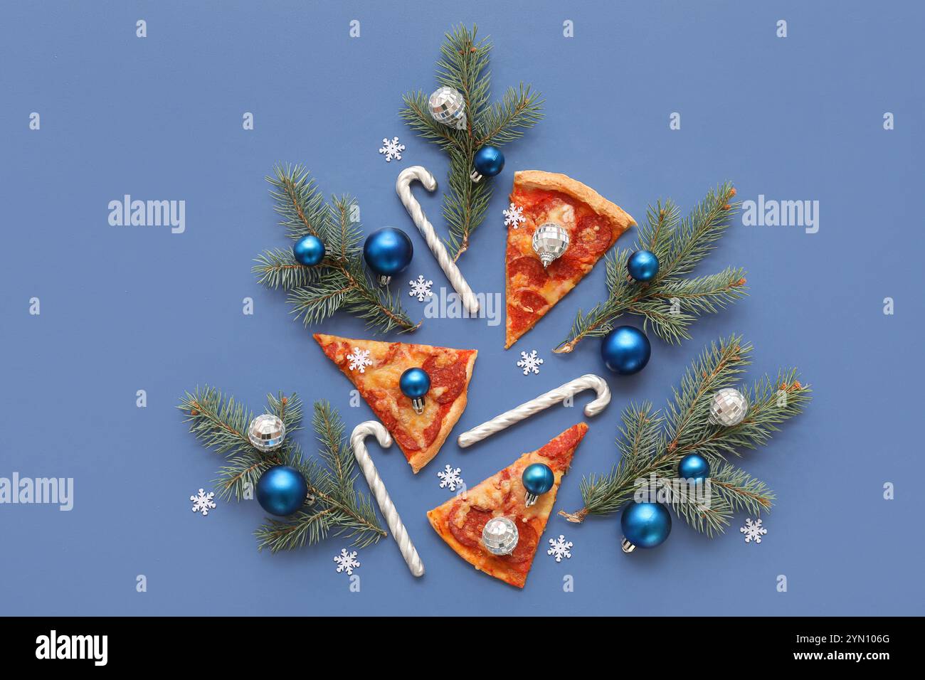 Christmas tree made of pizza slices, fir branches and balls on blue ...