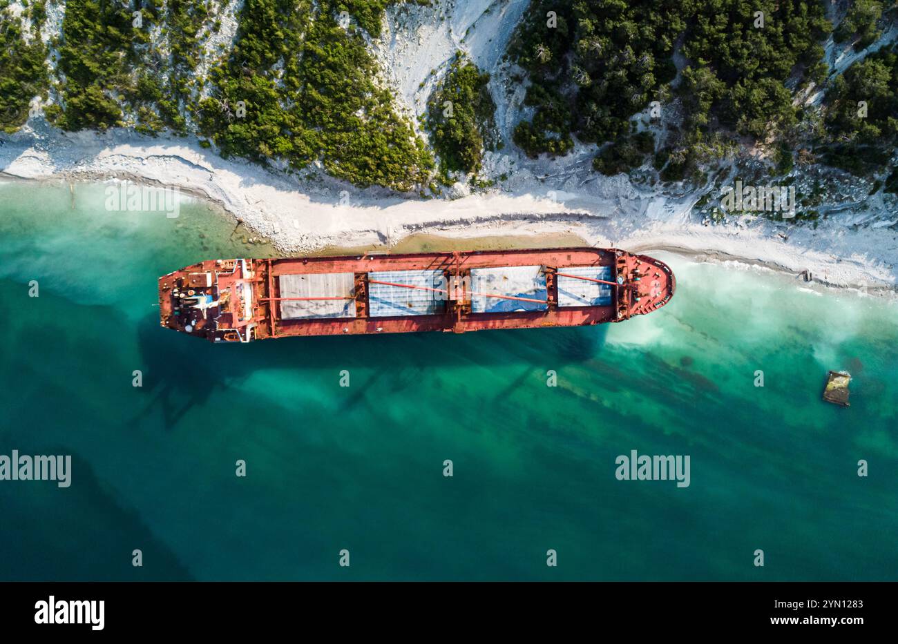 Aerial top down view of an abandoned bulk-carrier dry cargo ship washed ...