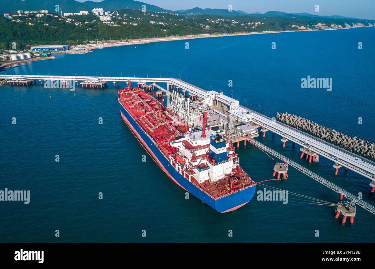 Aerial view of a large oil tanker docked at a pier in the port in ...
