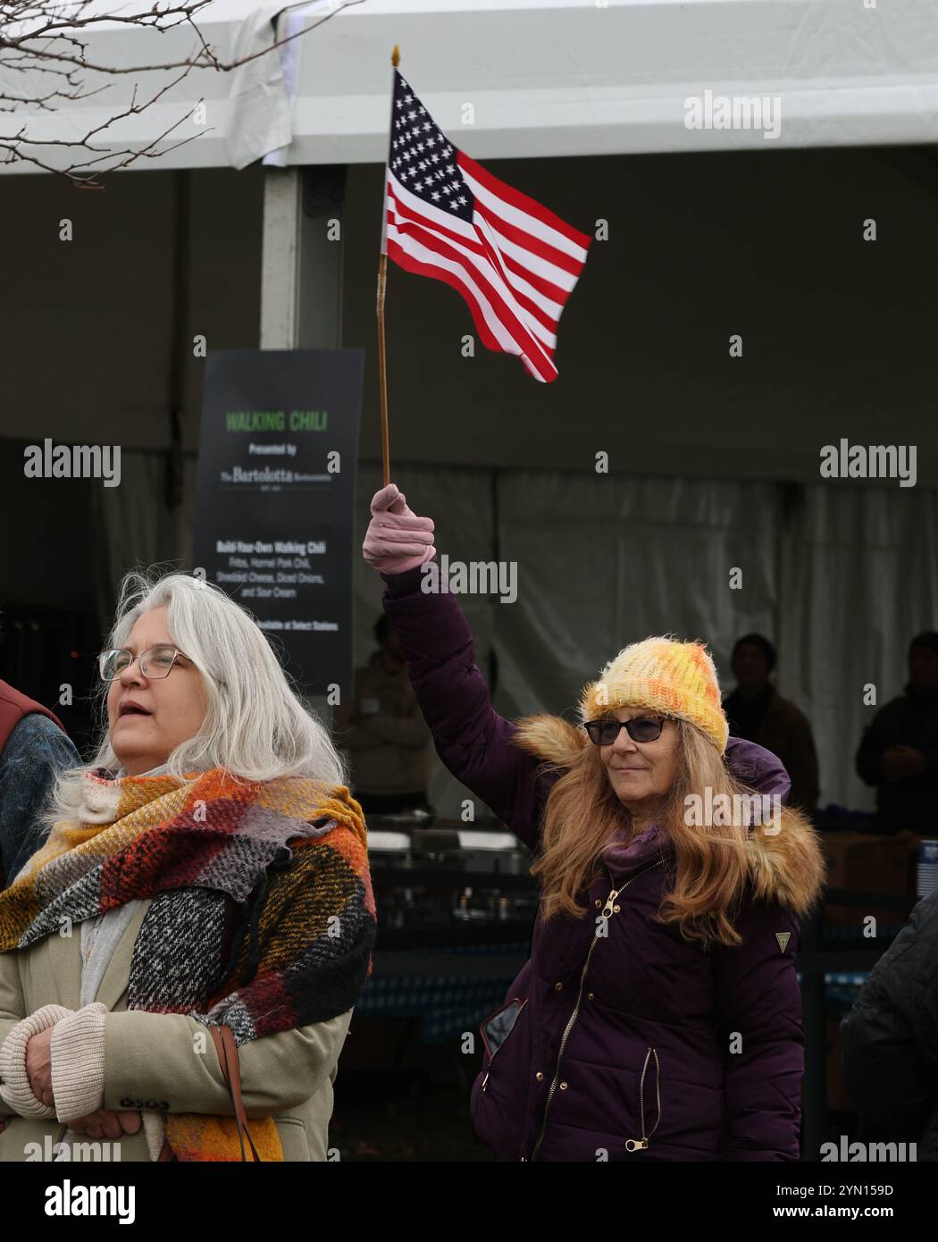 November 23, 2024, Milwaukee, Wisconsin, U.S: A woman waves her America ...