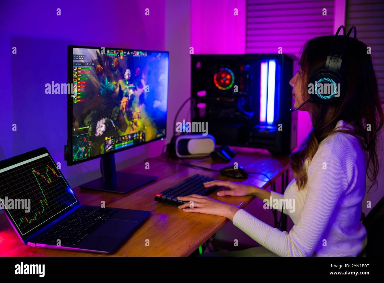 Asian professional gamer playing online video game on desktop computer ...