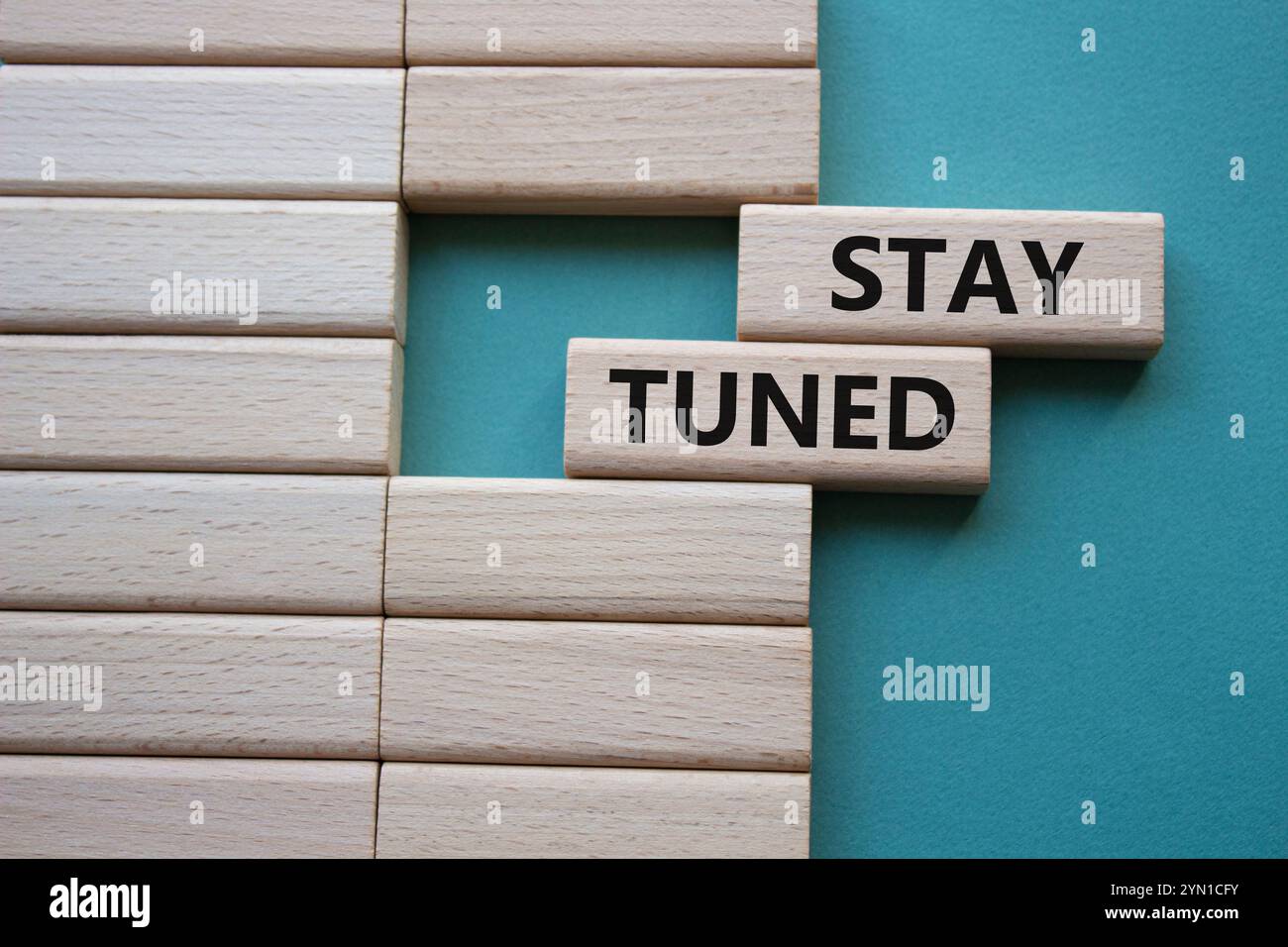 Stay Tuned symbol. Wooden blocks with words Stay Tuned Beautiful grey ...