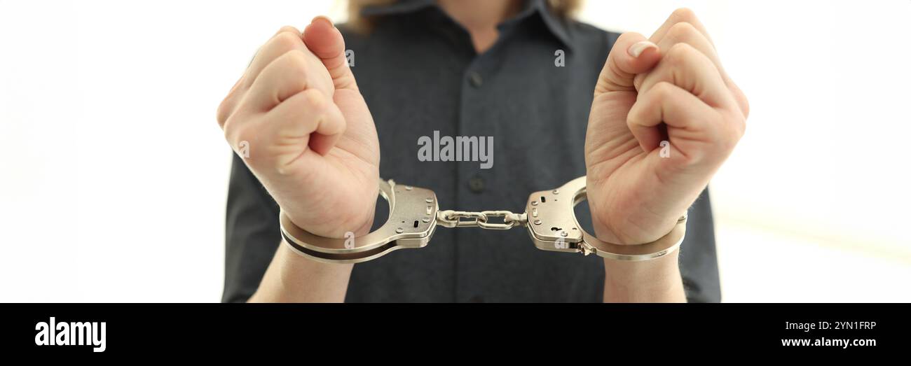 Female person with handcuffs on wrists in prison cell Stock Photo - Alamy