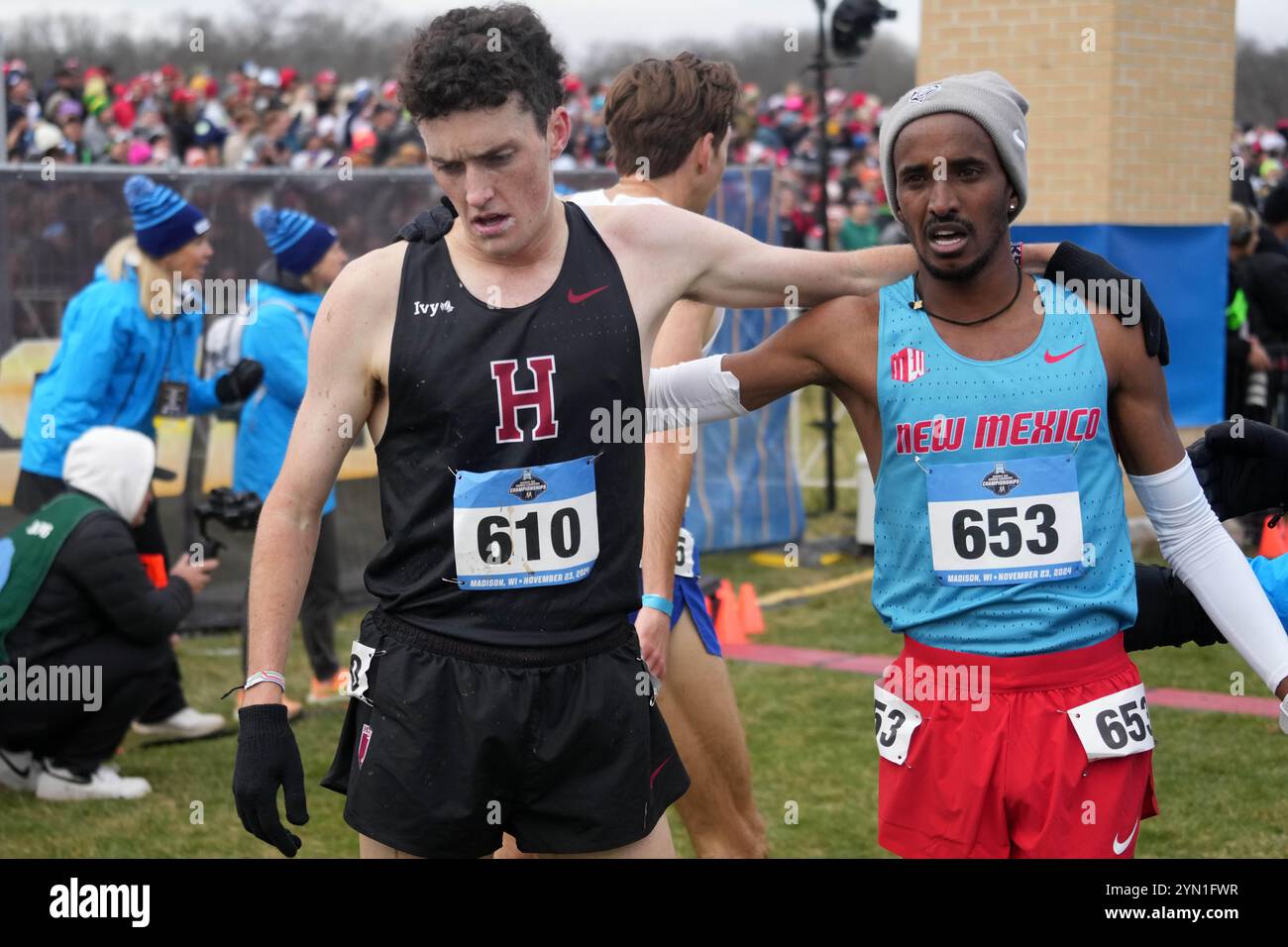 Graham Blanks of Harvard (left) and Habtom Samuel of New Mexico embrace ...