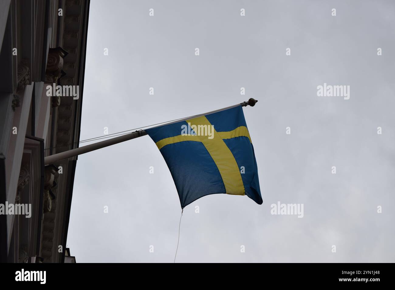Sweden flag on grey sky background Stock Photo - Alamy
