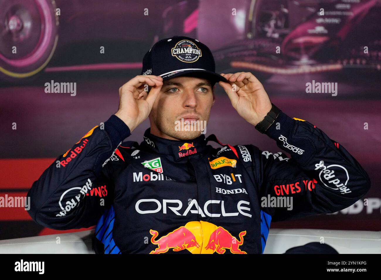 Red Bull driver Max Verstappen, of the Netherlands, adjusts his hat ...