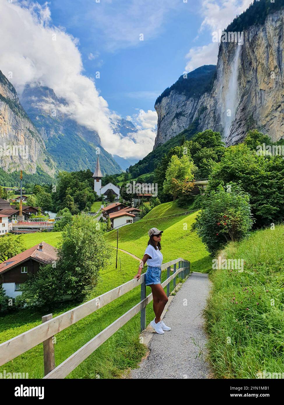 Standing on a peaceful path, a traveler enjoys the breathtaking view of ...