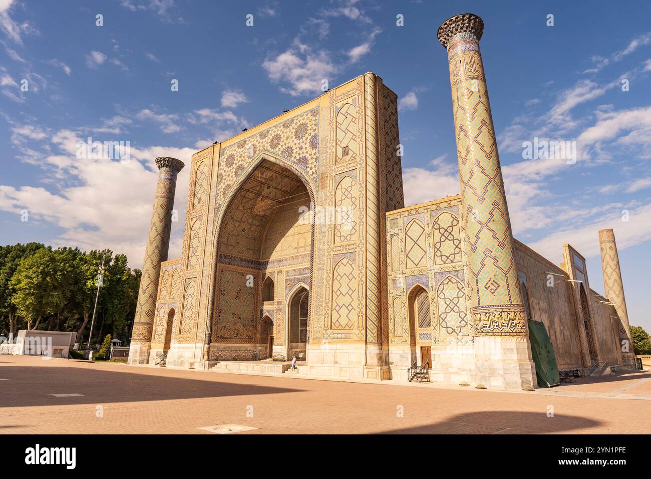 The imposing beauty of a Registan Square madrasa with its grand arch ...