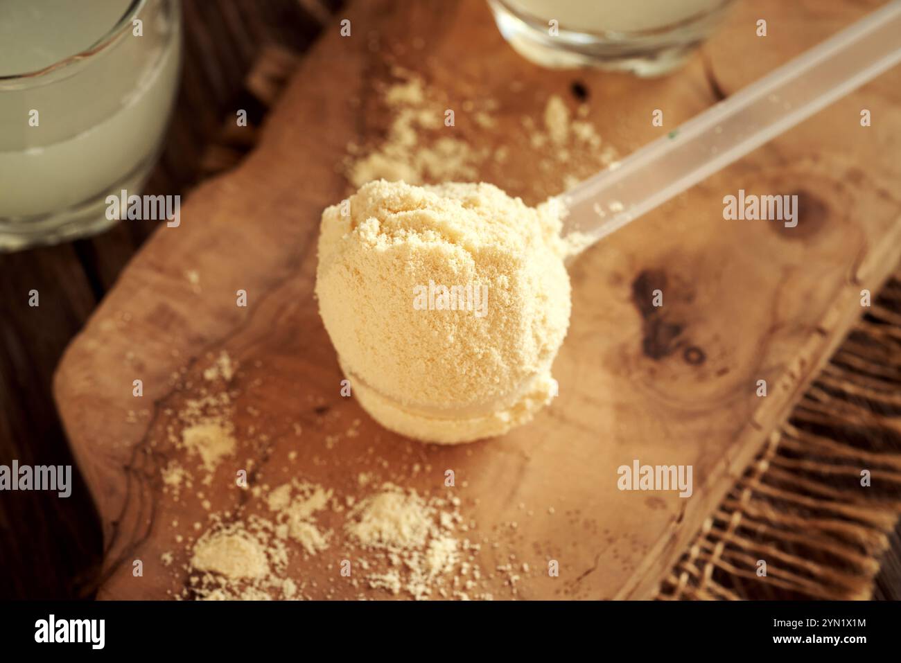 Whey protein powder in a measuring cup Stock Photo - Alamy
