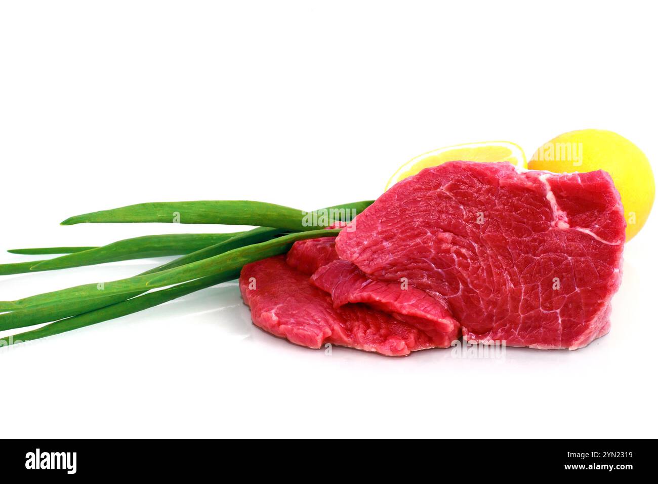 Cut of beef steak with lemon slice and onion. Isolated Stock Photo - Alamy