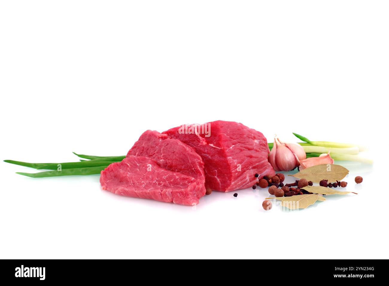 Cut of beef steak with garlic slice, onion and laurel. Isolated Stock ...