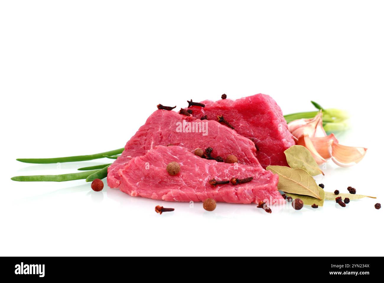 Cut of beef steak with garlic slice, onion and laurel. Isolated Stock ...