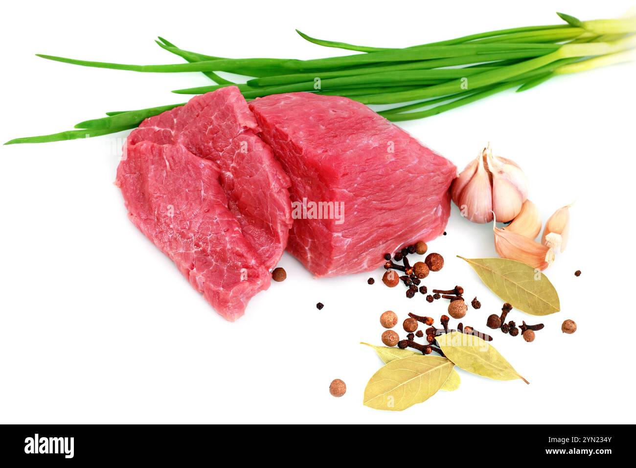 Cut of beef steak with garlic slice, onion and laurel. Isolated Stock ...