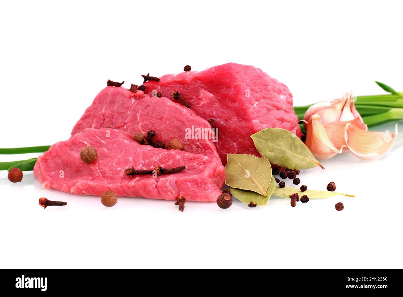 Cut of beef steak with garlic slice, onion and laurel. Isolated Stock ...