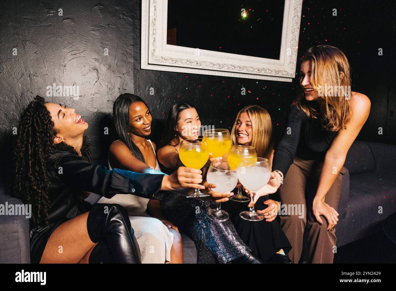 A group of cheerful friends enjoying a joyful evening together and ...
