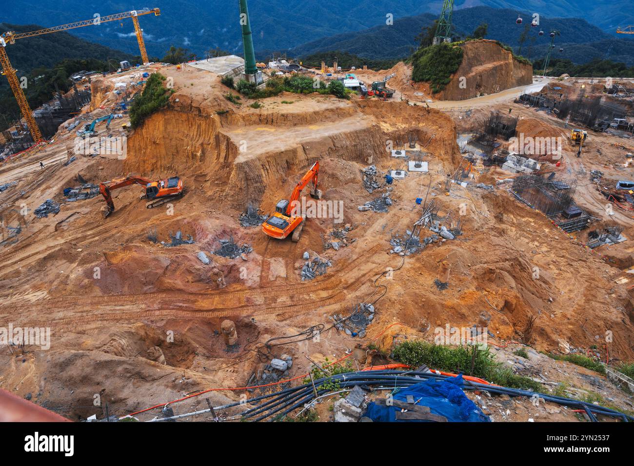 construction site with excavators digging pit for foundation of a ...