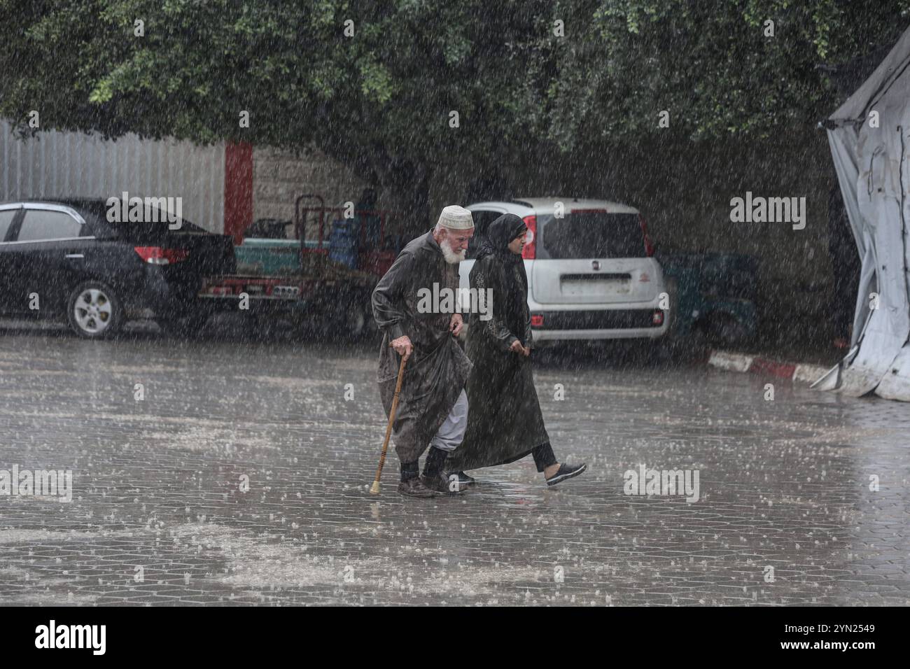 Palestinians, navigating winter conditions in clothing and slippers ill ...