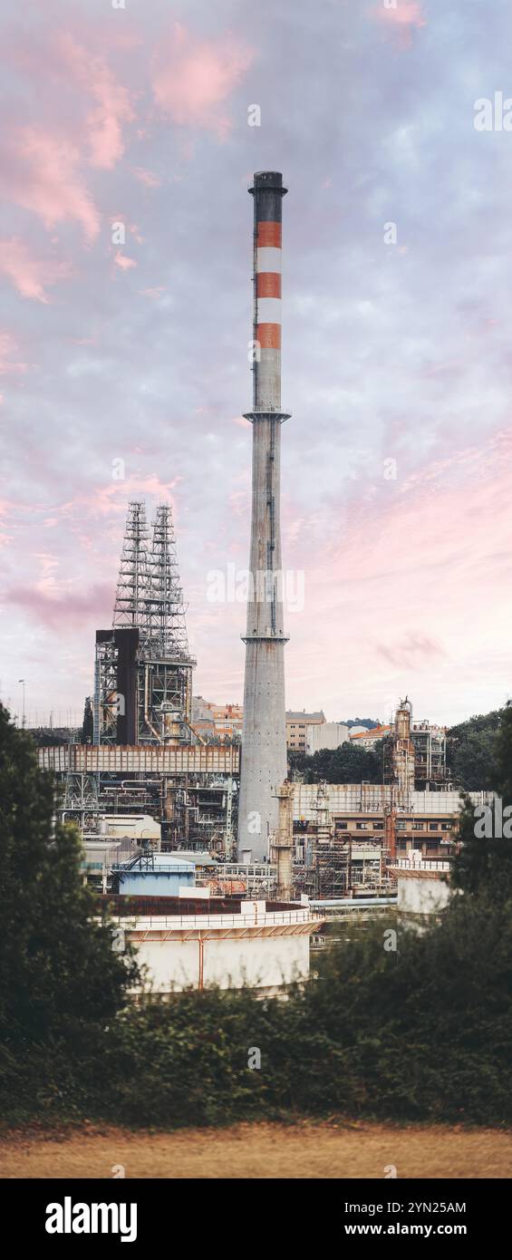 Industrial telephoto vertorama of a refinery complex with a tall ...
