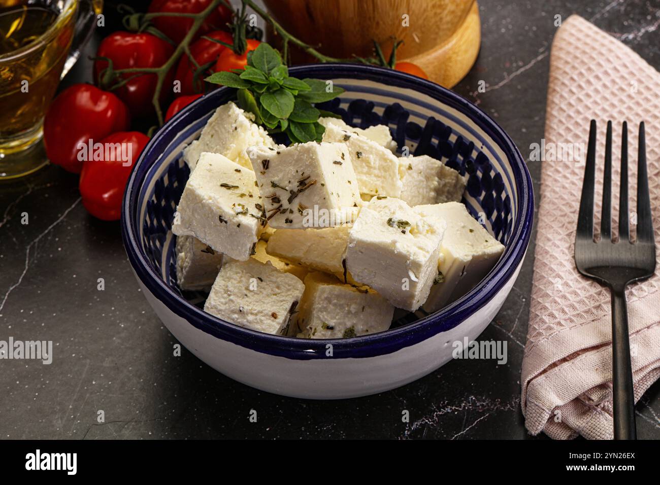 Greek traditional Feta cheese cubes with herbs and spices Stock Photo ...