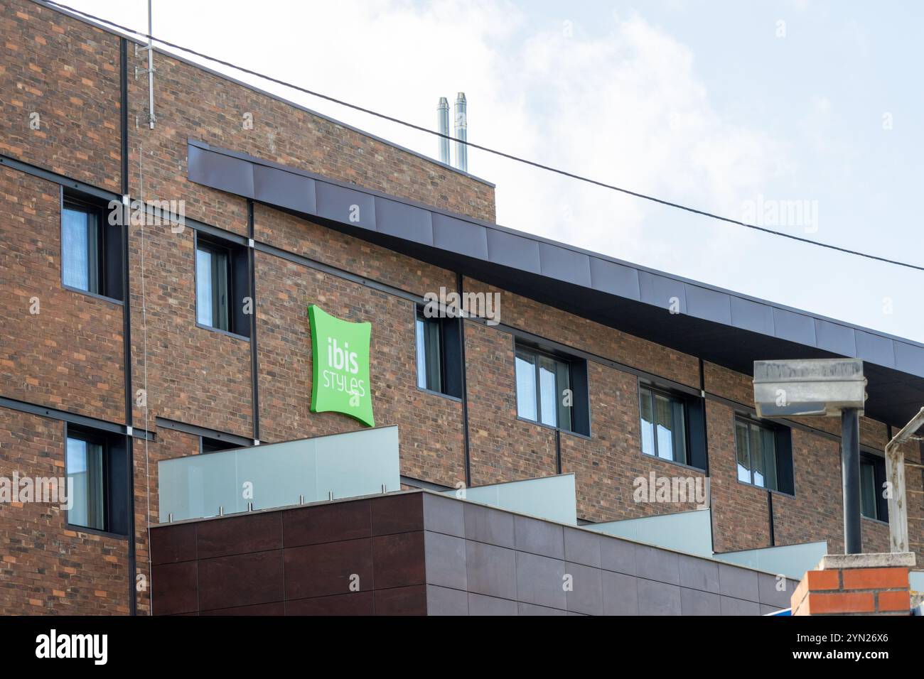Green ibis styles hotel sign on a modern brick building facade Stock ...