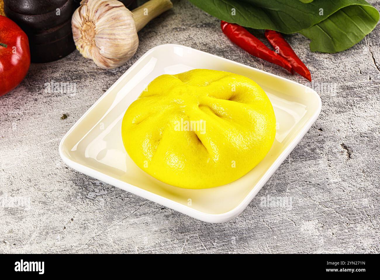 Asian stuffed steamed yellow Bun Bao Stock Photo - Alamy
