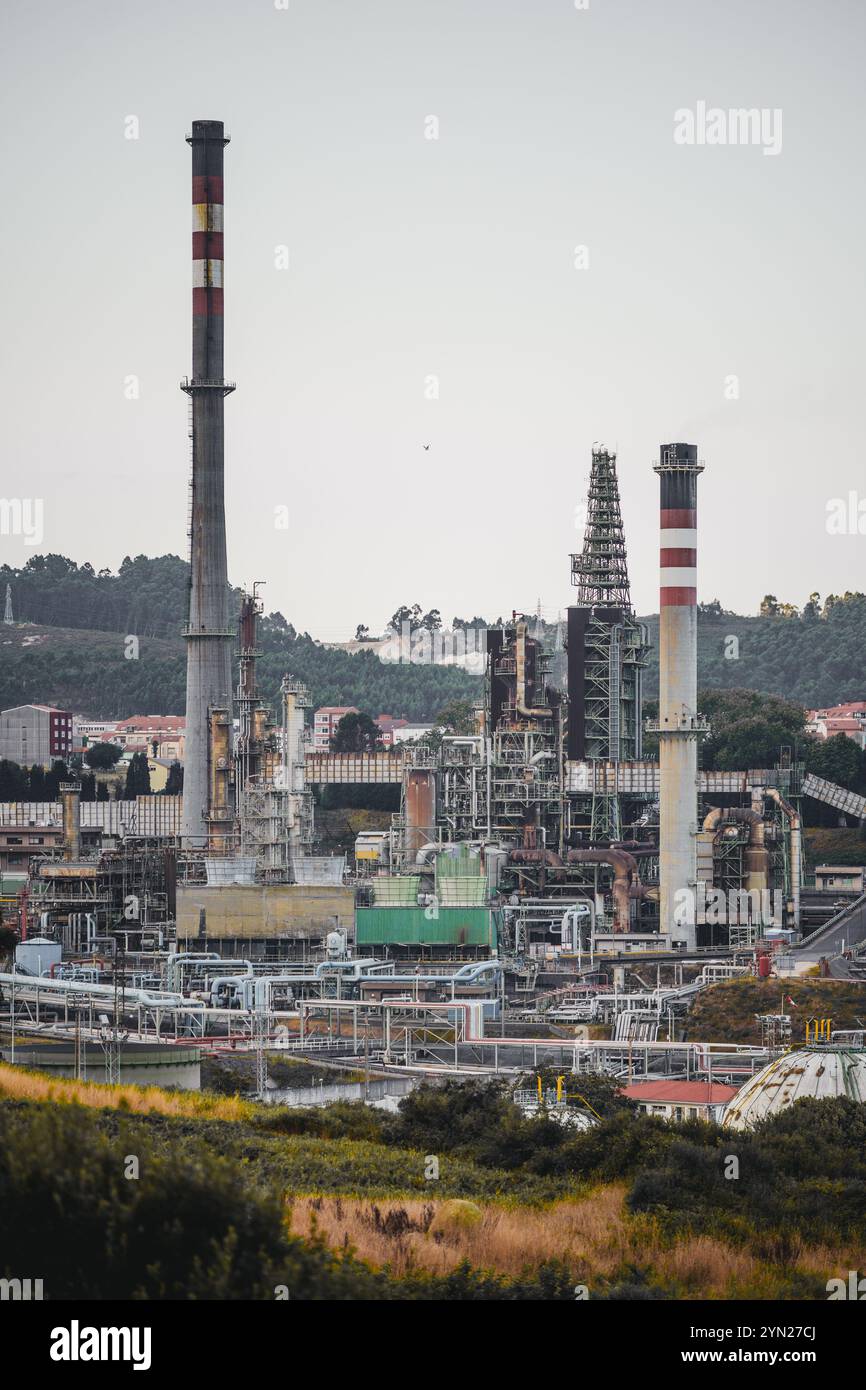 Industrial refinery complex with tall chimneys, metal structures ...