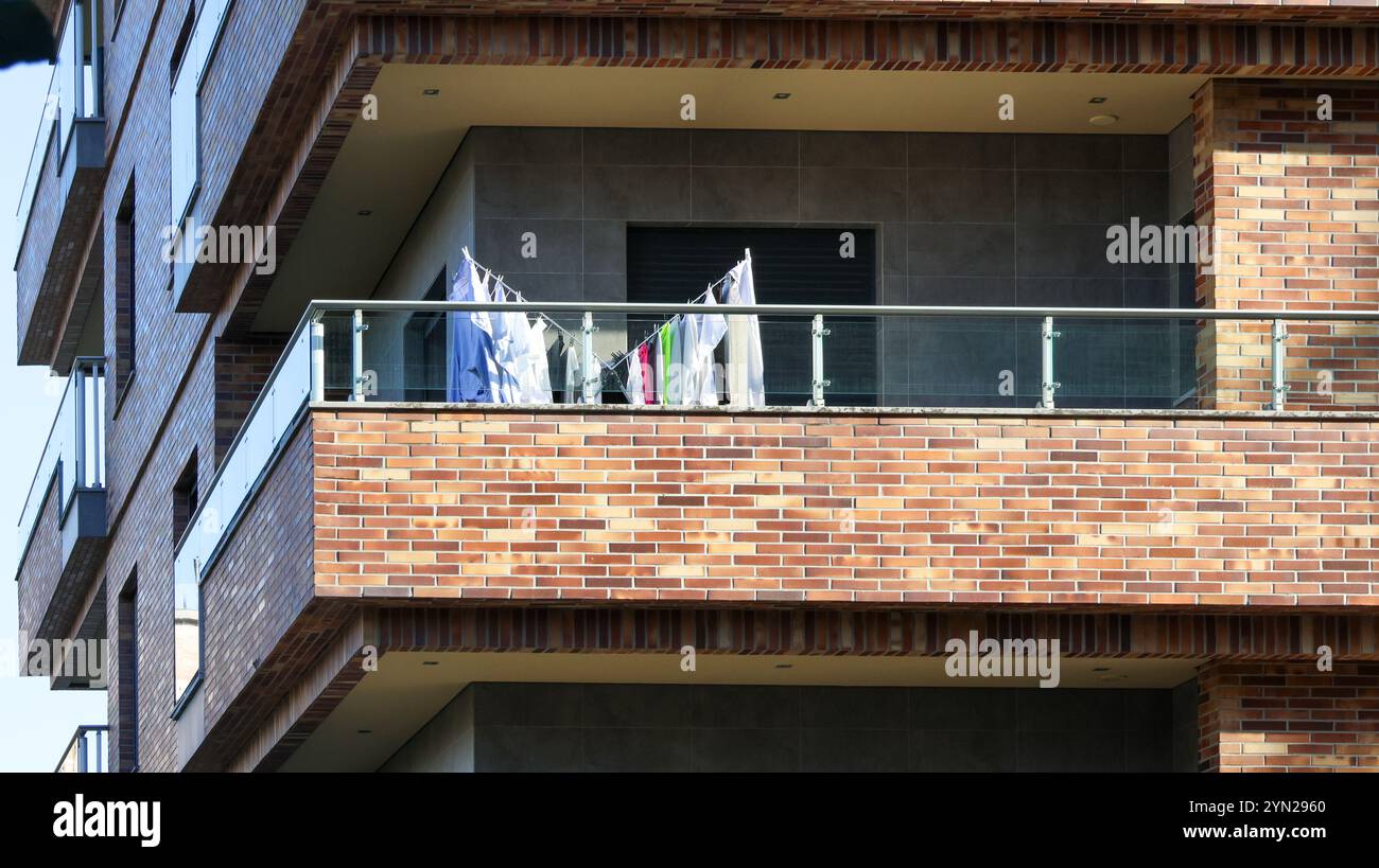 Laundry drying on a clothesline on a balcony of a modern residential ...