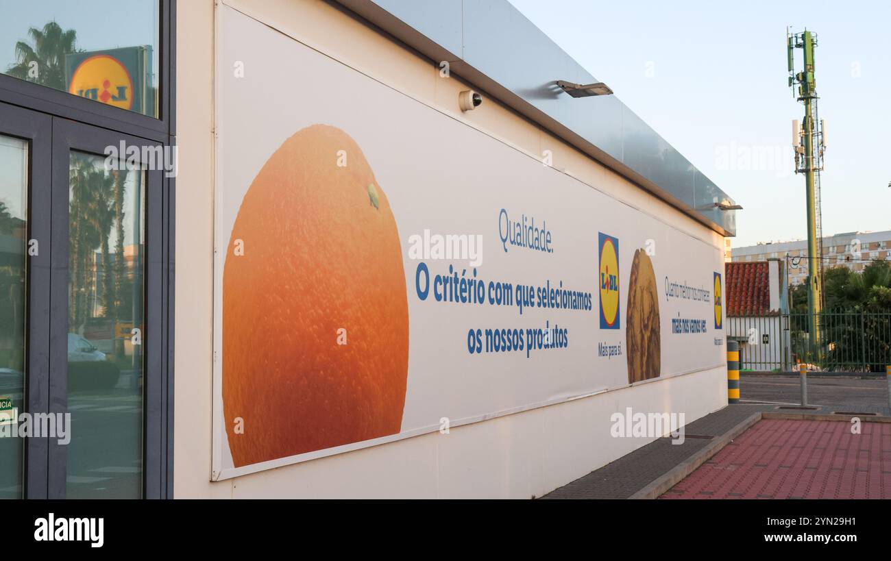 Lidl supermarket displays a large billboard featuring an orange and a ...