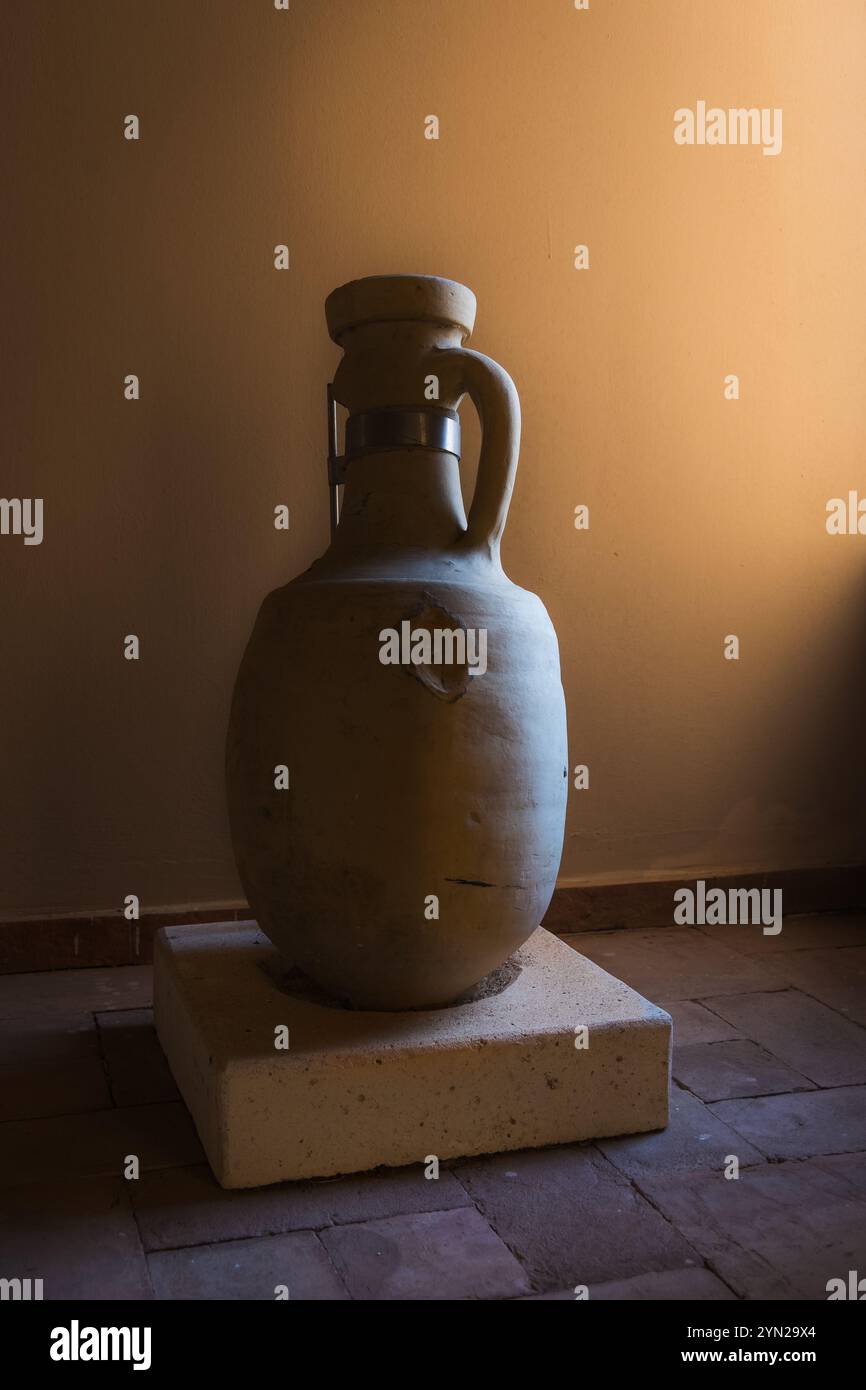 Ancient Roman clay pot with handle isolated on a dark background ...