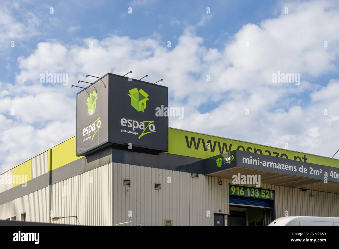 Modern self storage facility under a bright blue sky, showcasing the ...