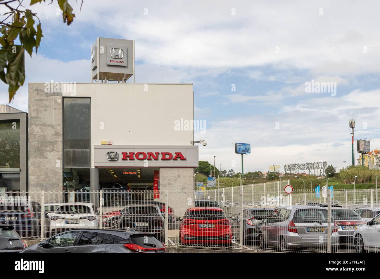 Honda car dealership building with prominent signage and a parking lot ...