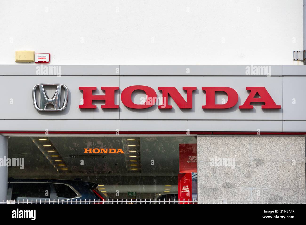 Red honda logo prominently displayed on the exterior of a car ...